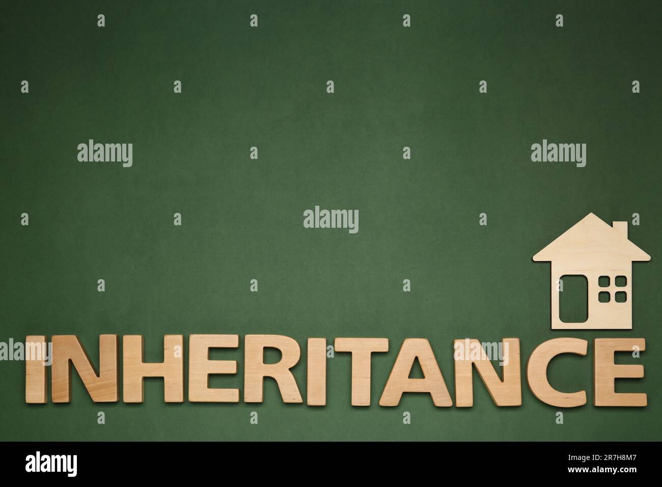 Word Inheritance made with wooden letters and house model on green ...