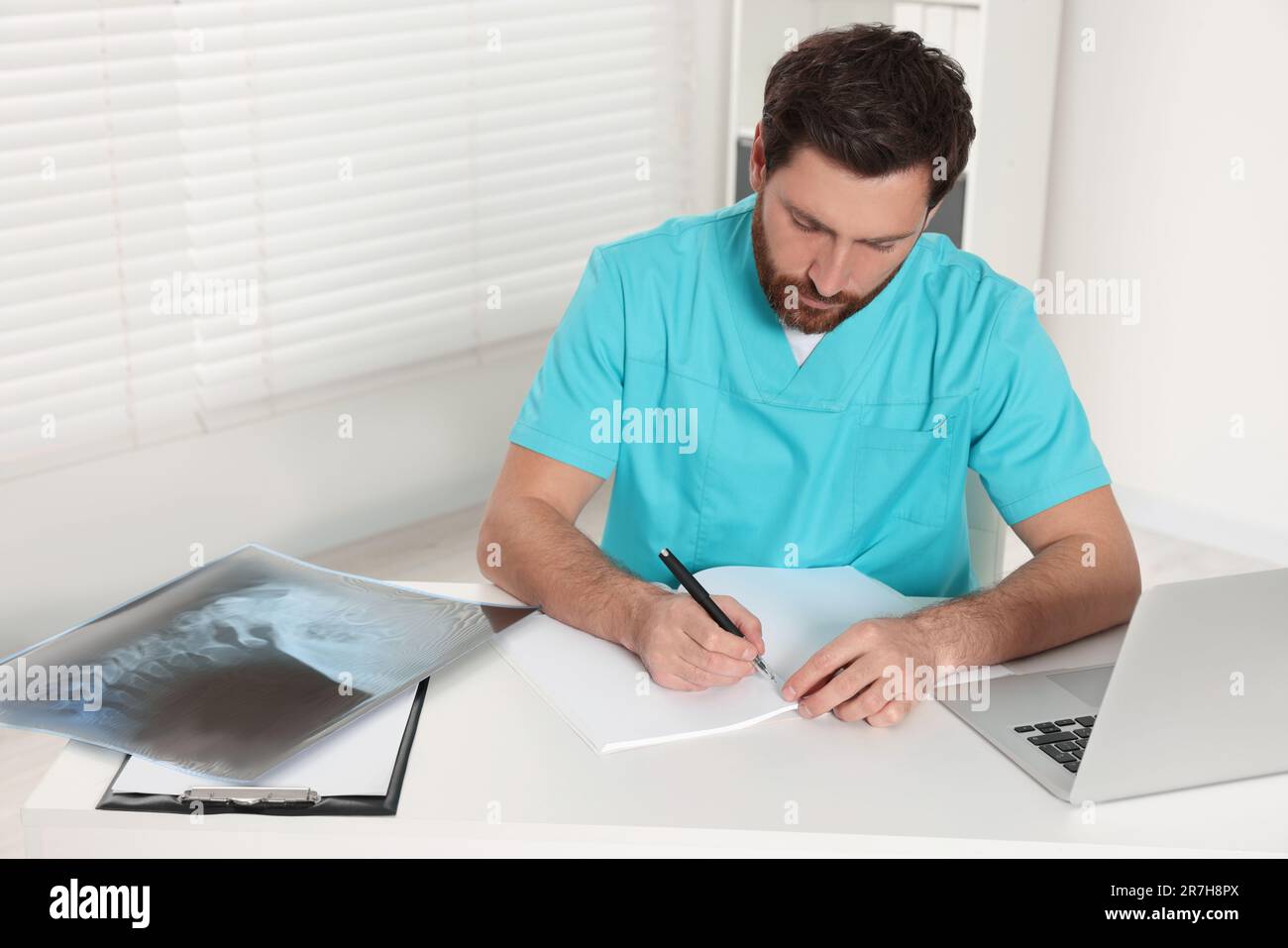 Doctor writing results from MRI scan in hospital Stock Photo - Alamy