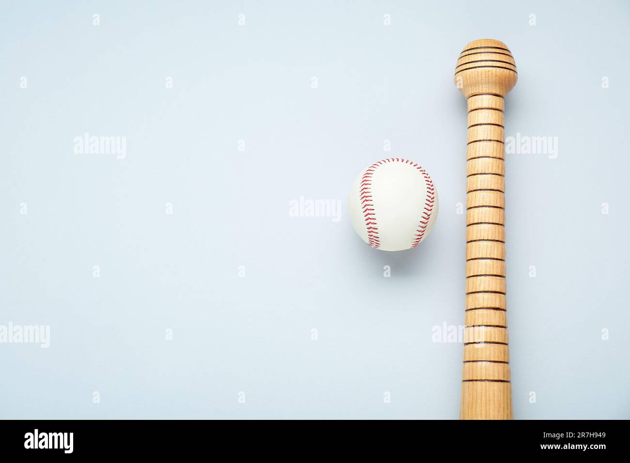 Wooden baseball bat and ball on light grey background, flat lay. Space ...