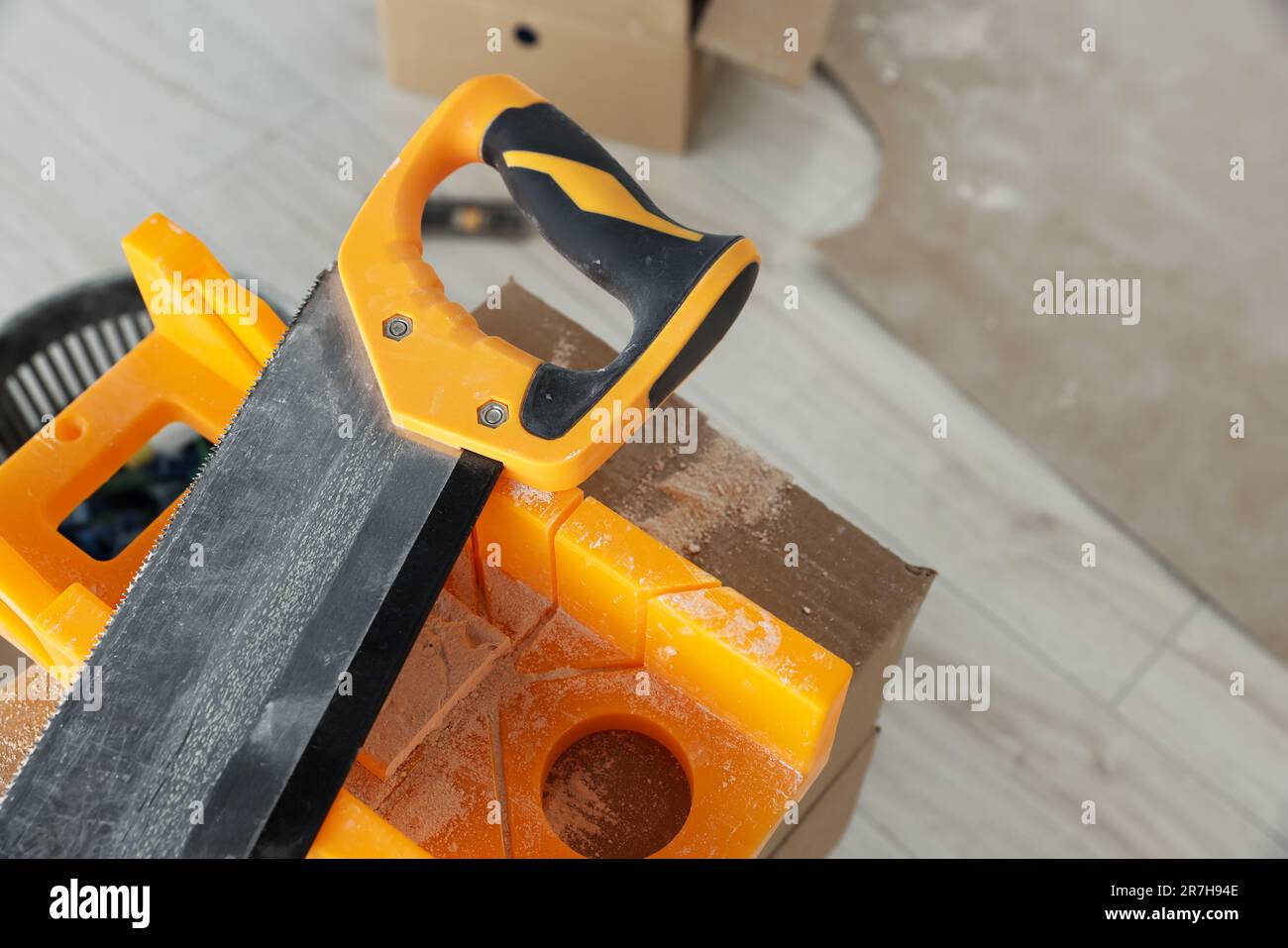 Saw and miter box for decorative brick installation indoors, closeup ...