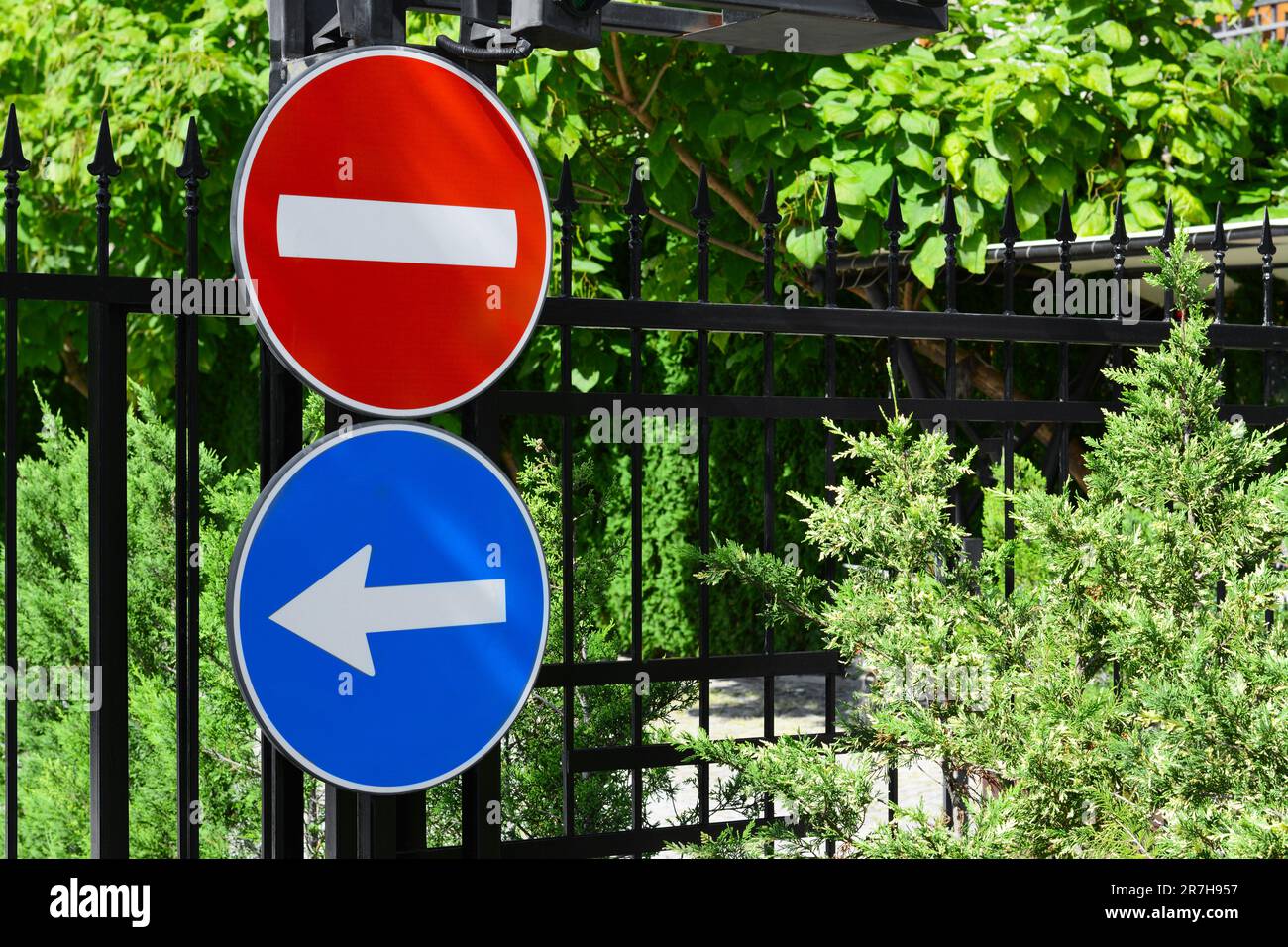 Post with No Entry sign and arrow outdoors on sunny day, space for text ...