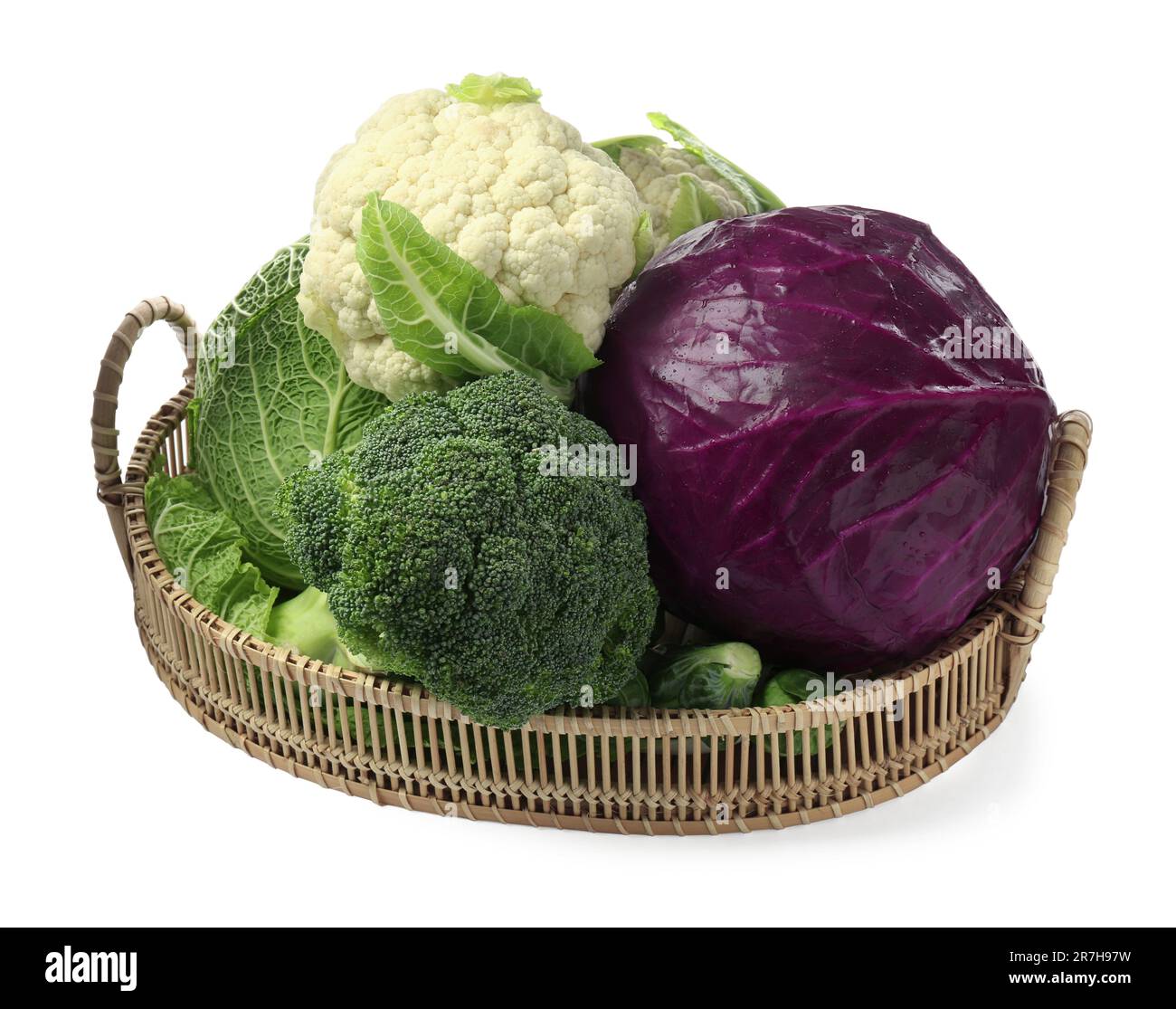 Wicker tray with different types of fresh cabbage on white background ...