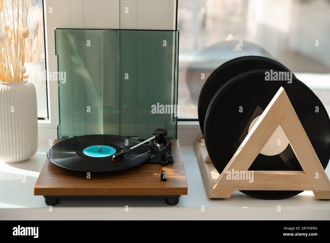 Vinyl records and player on white window sill Stock Photo - Alamy