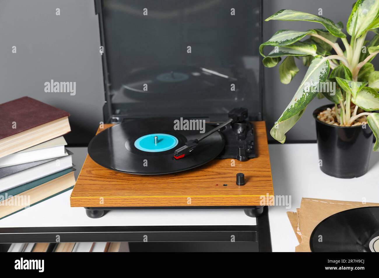 Stylish turntable with vinyl disc near grey wall in room Stock Photo ...