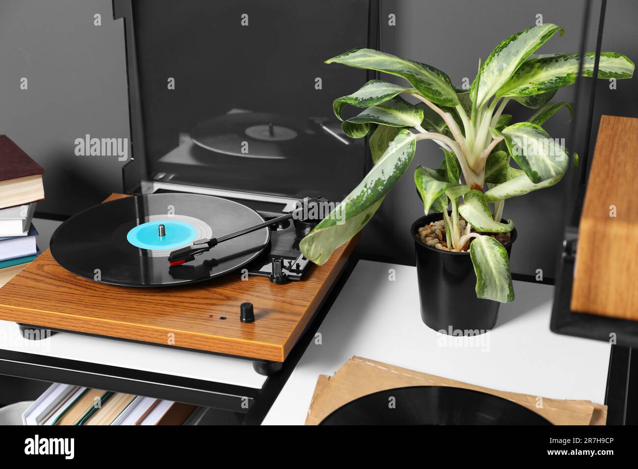 Stylish turntable with vinyl disc near grey wall in room Stock Photo ...