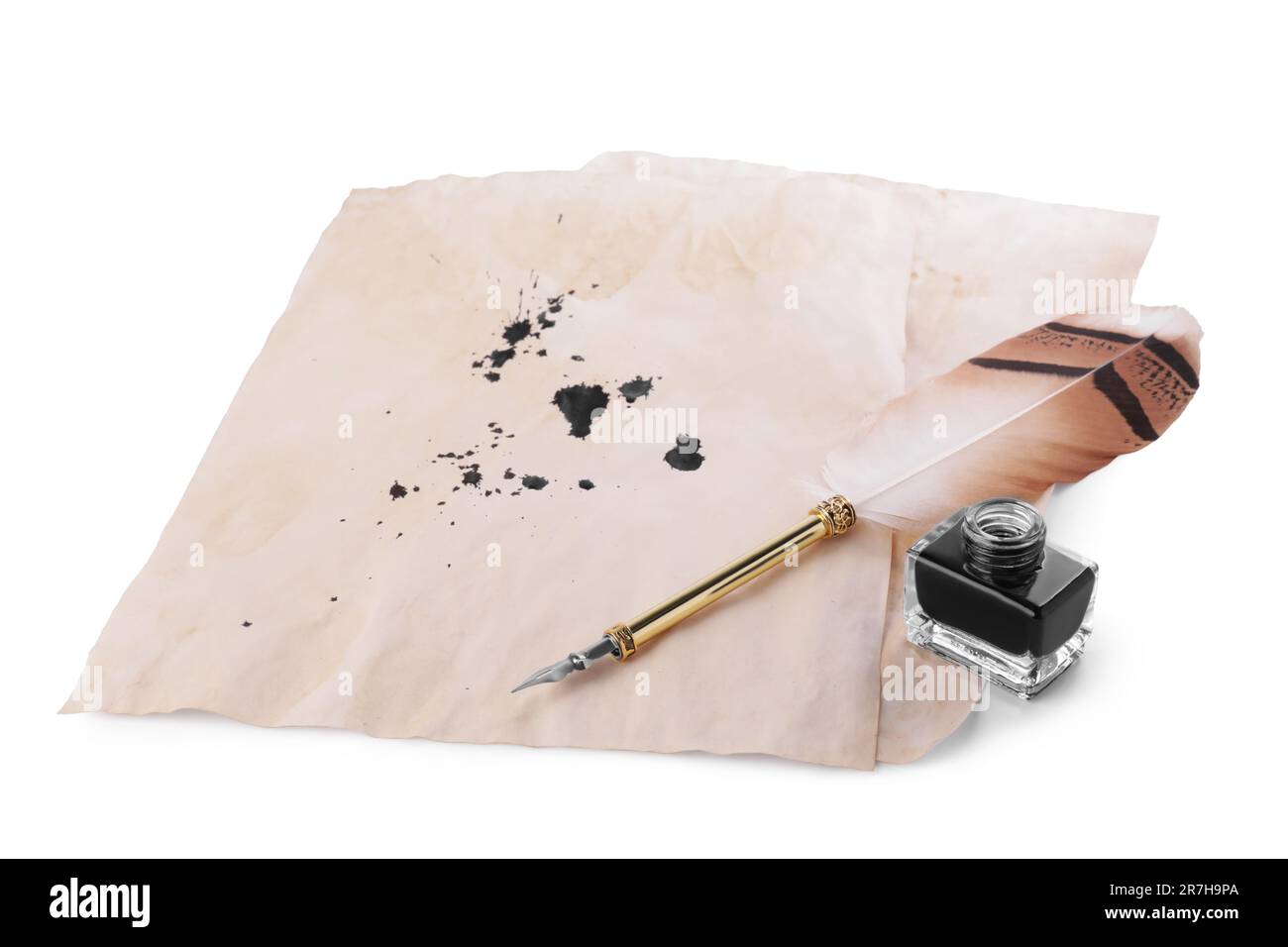 Parchment with stains of ink, feather pen and inkwell on white ...