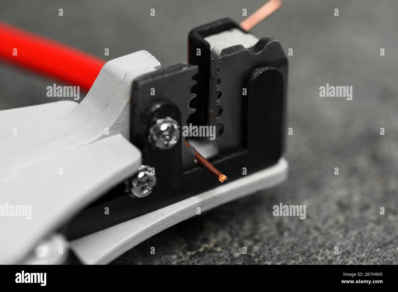 Cutters and stripped wire on light gray textured table, closeup Stock ...
