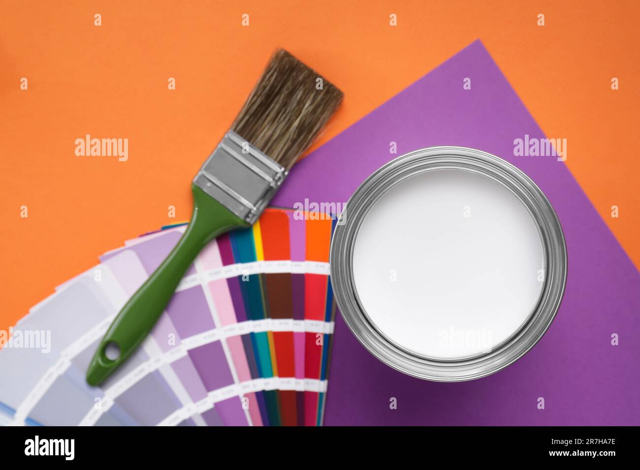 Can with white paint, color palette and brush on color background, flat ...
