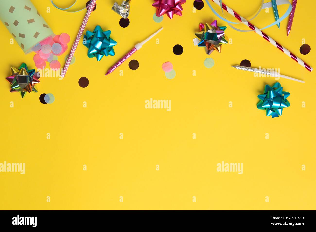 Party popper with confetti, blower and festive decor on orange ...