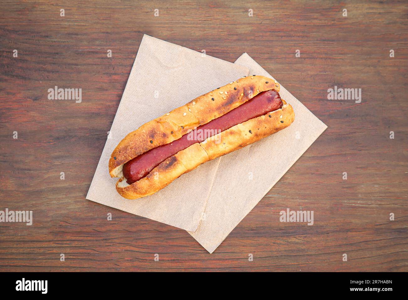 Fresh tasty hot dog on wooden table, top view Stock Photo - Alamy