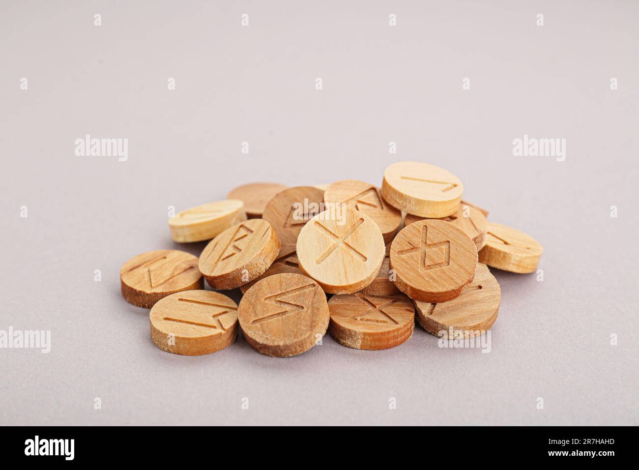 Pile of wooden runes on light grey background Stock Photo - Alamy