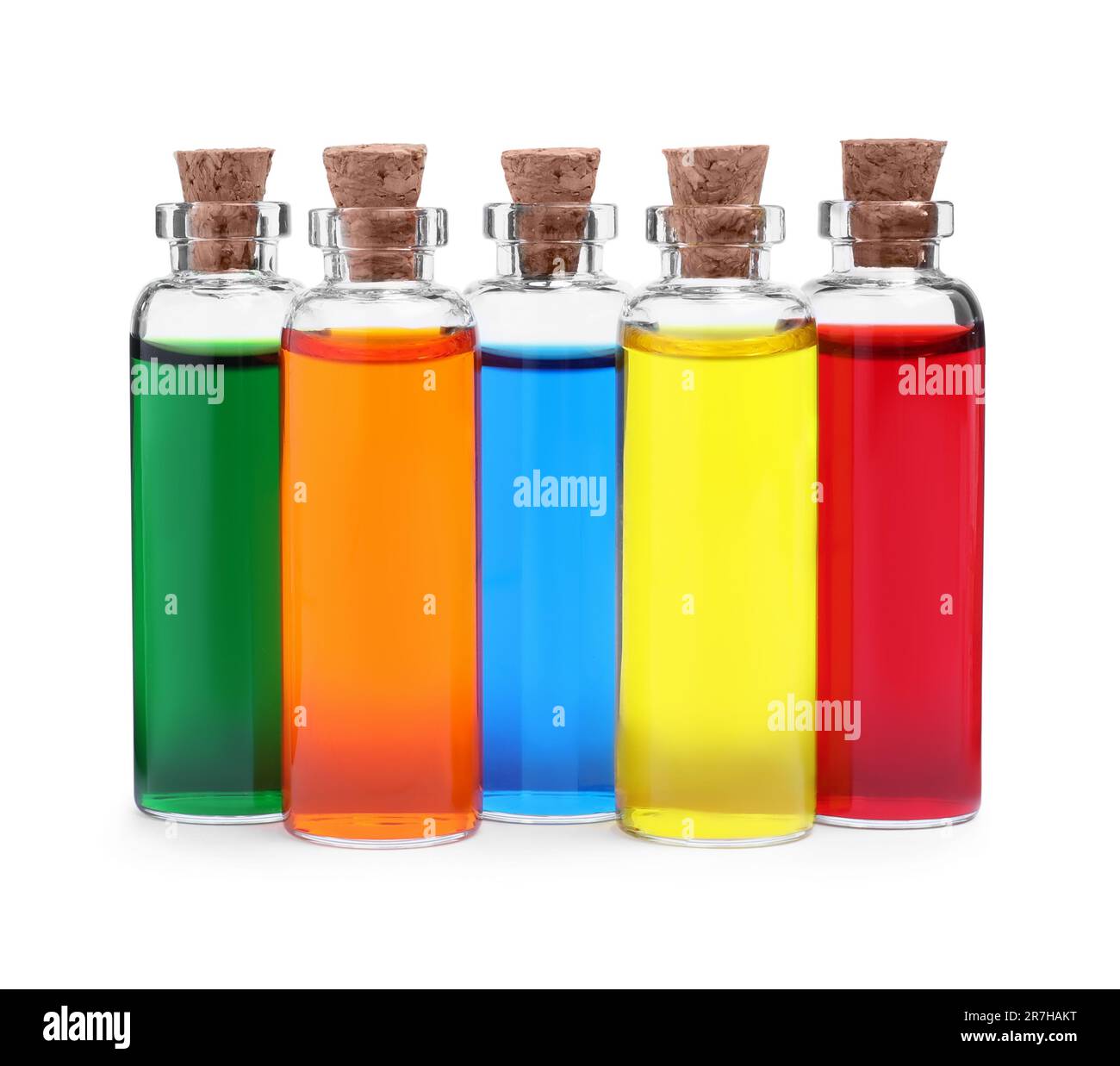 Glass bottles with different food coloring on white background Stock ...