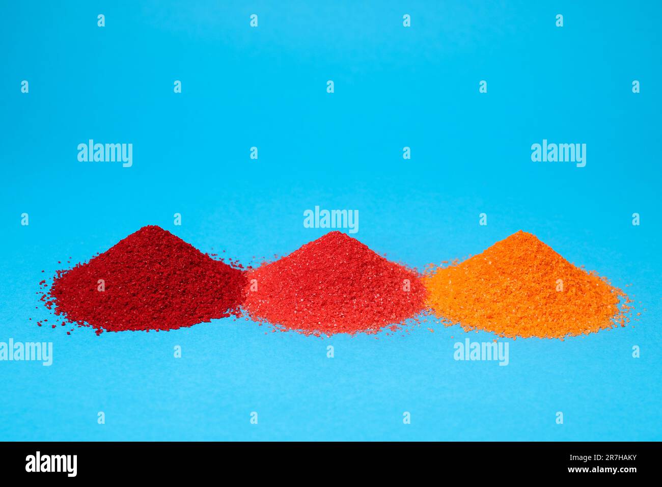 Heaps of different bright food coloring on light blue background Stock ...