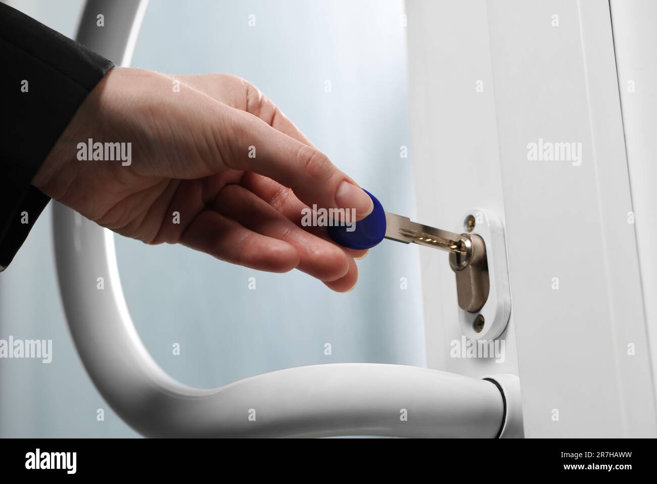 Woman unlocking door with key, closeup view Stock Photo - Alamy