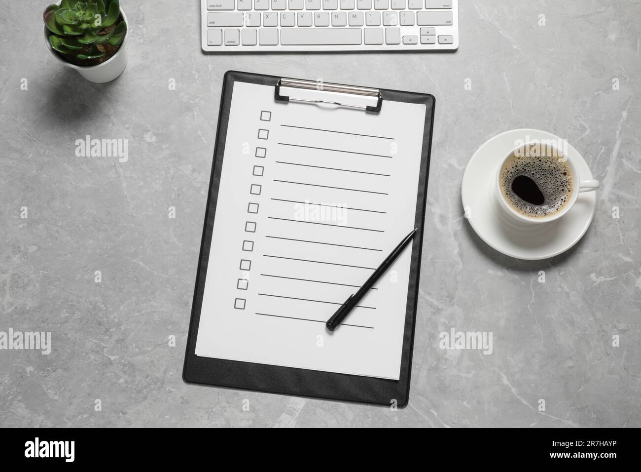 Clipboard with checkboxes, cup of coffee plant and computer keyboard on ...