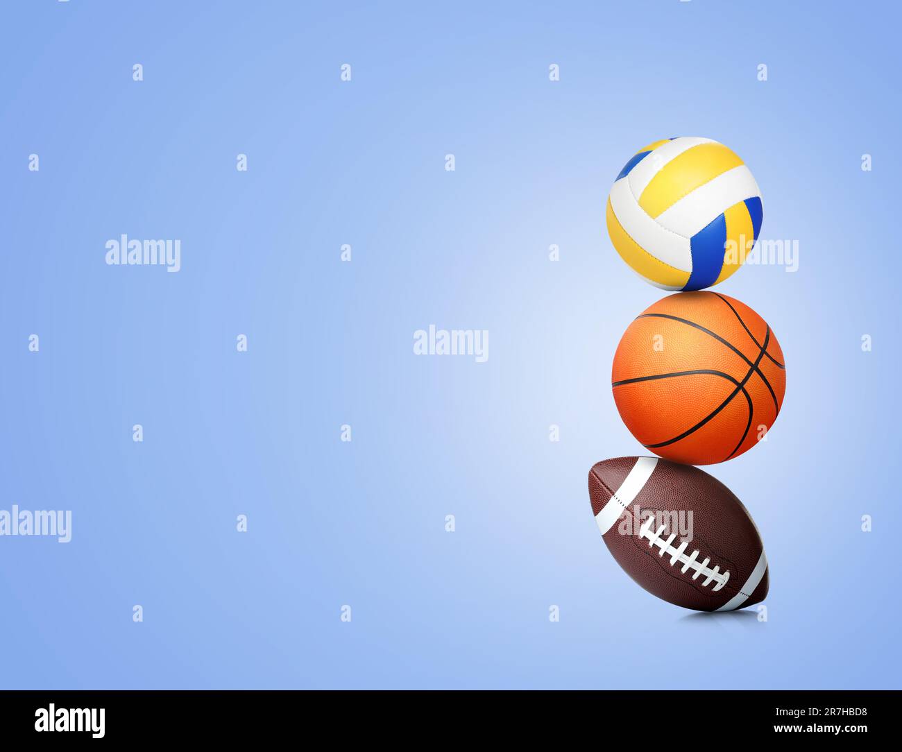 Stack of different sport balls on pale blue background, space for text ...