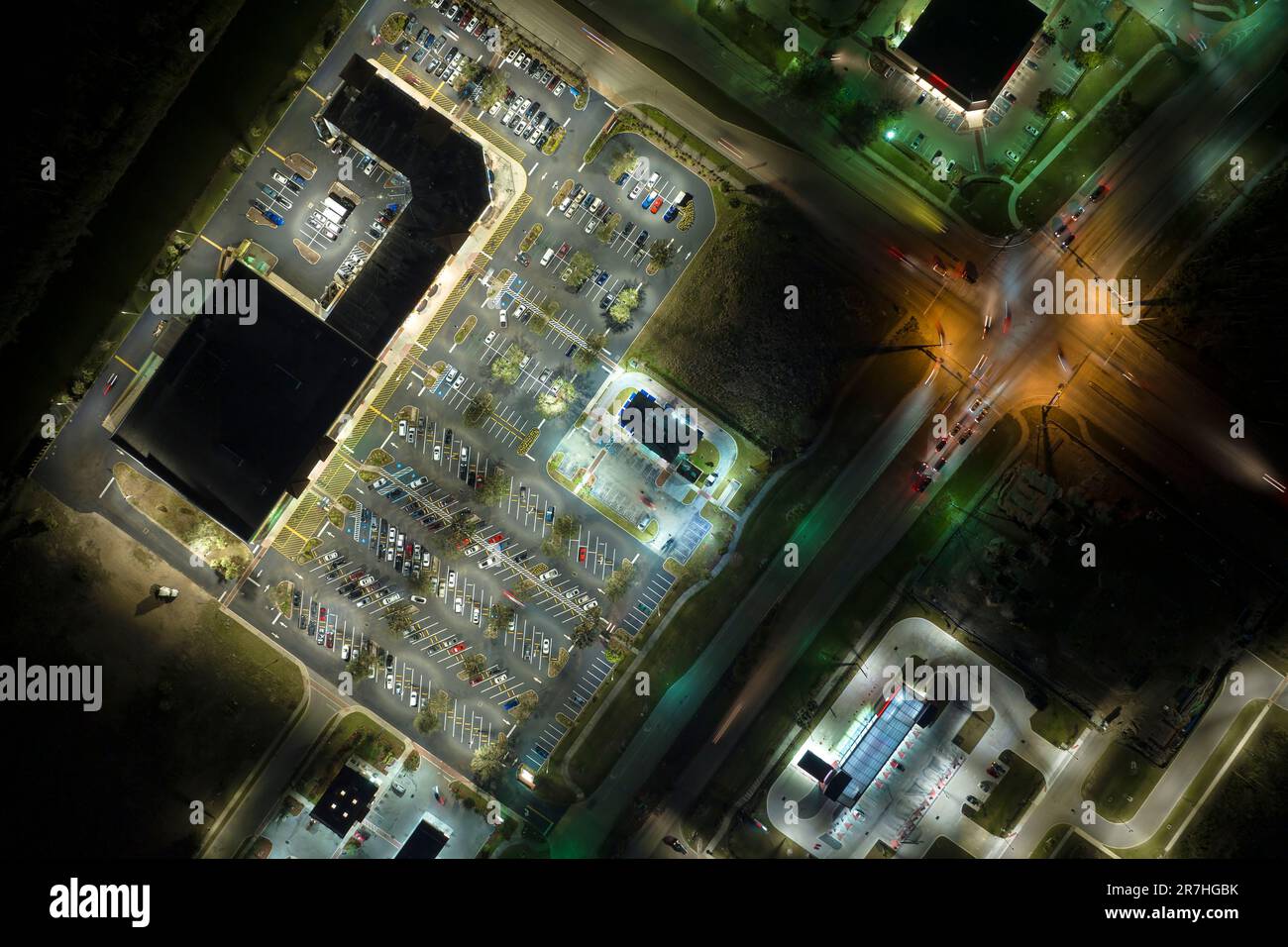 Aerial night view of many cars parked on parking lot with lines and ...