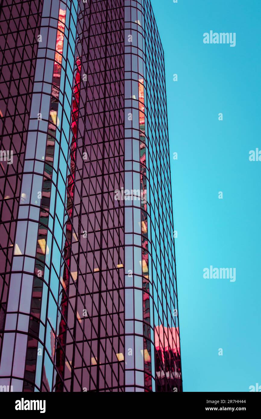 A modern architecture building illuminated by a vibrant blue twilight ...