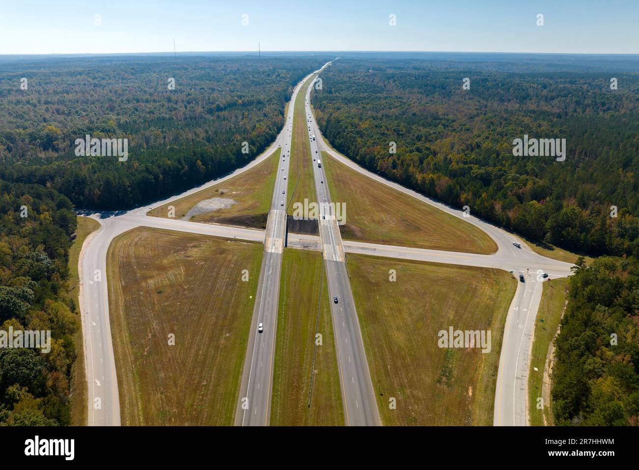 Aerial view of freeway overpass junction with fast moving traffic cars ...