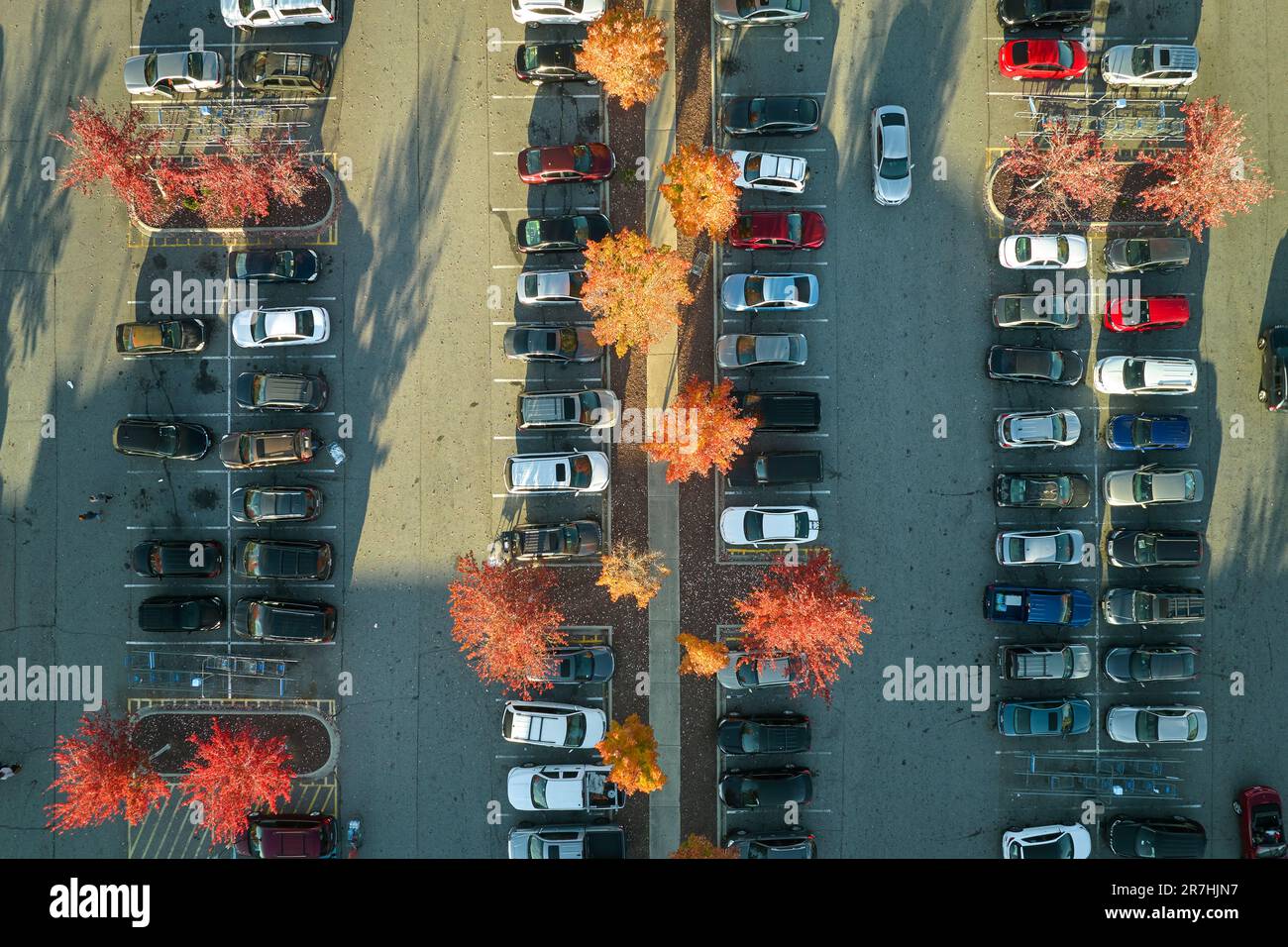 Aerial view of many colorful cars parked on parking lot with lines and ...
