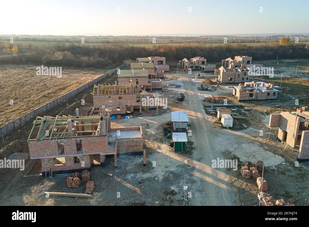 Aerial view of new homes with brick framework walls under construction ...