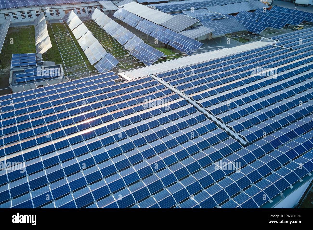 Aerial view of solar power plant with blue photovoltaic panels mounted ...