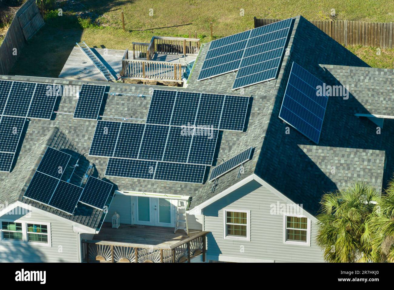American residential house with rooftop covered with solar photovoltaic ...
