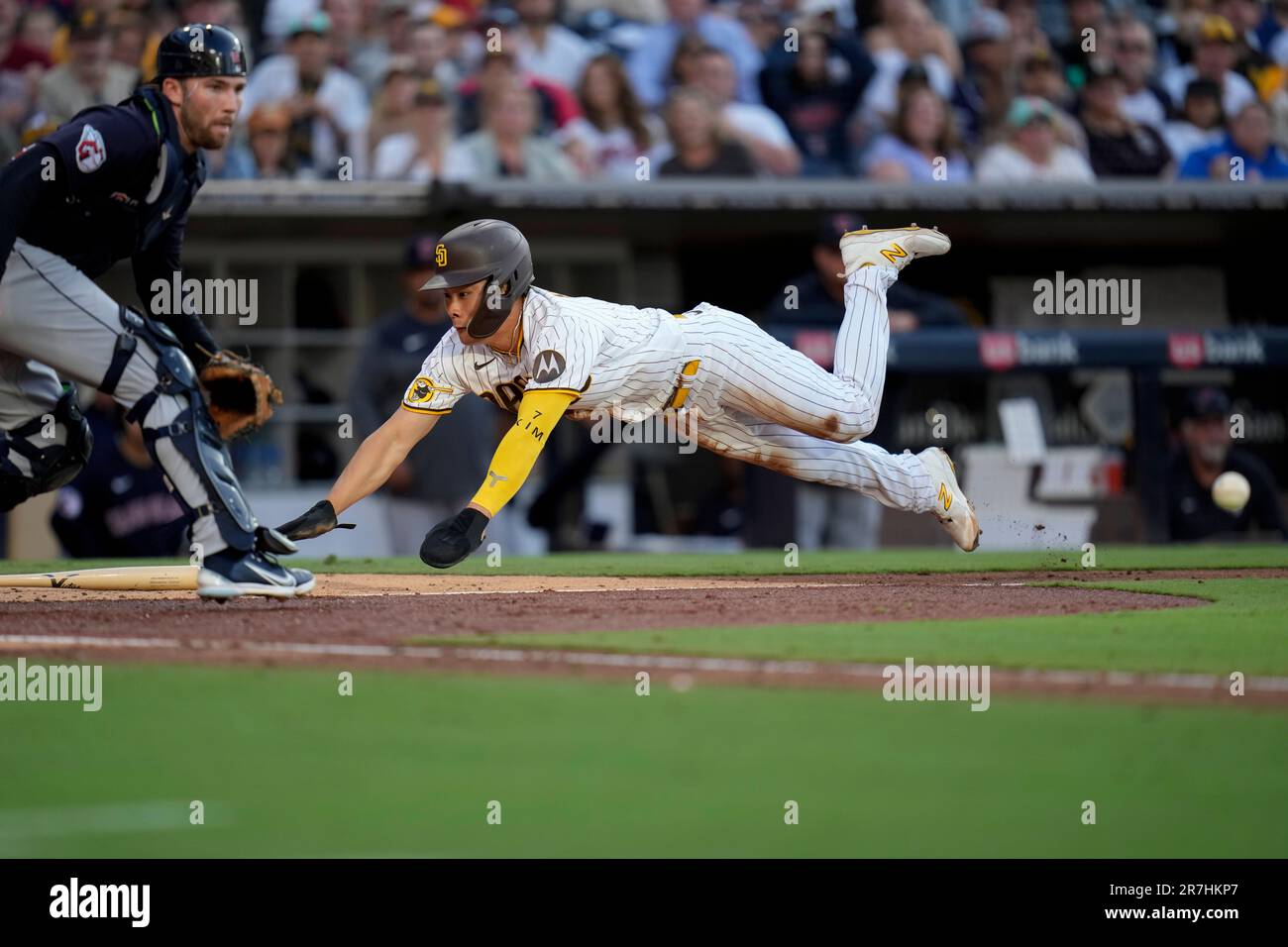 San Diego Padres' Ha-Seong Kim, center, slides home, scoring from ...