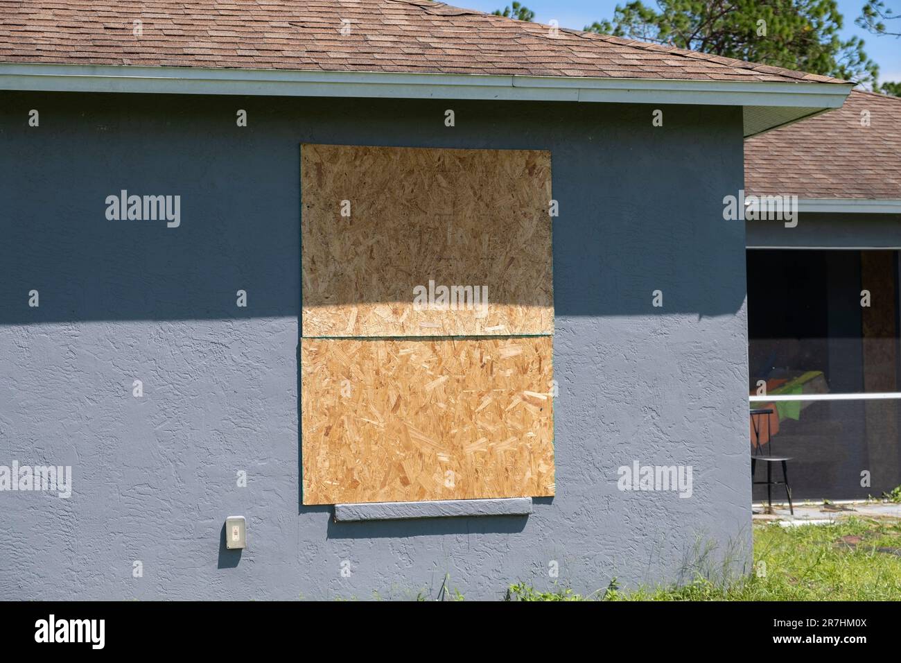 Boarded up windows with plywood storm shutters for hurricane protection ...