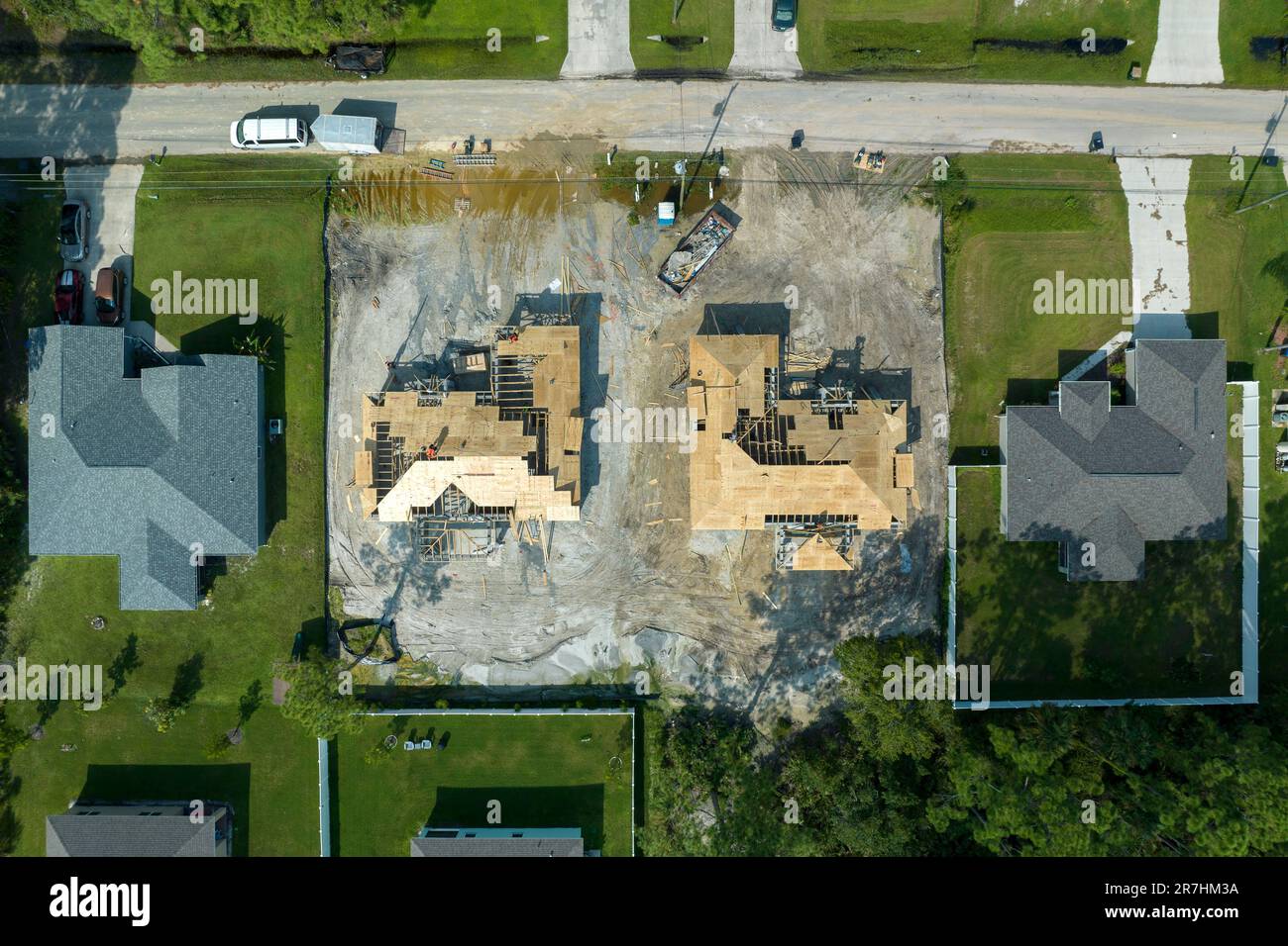 Builders working on roof construction of unfinished residential house ...
