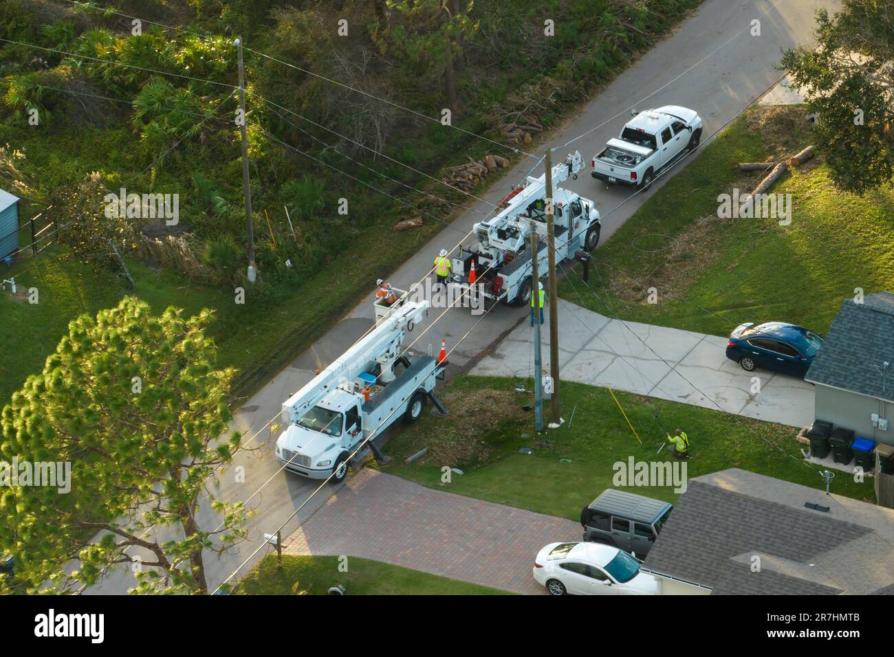 Electrical service company restoring power repairing damaged power ...