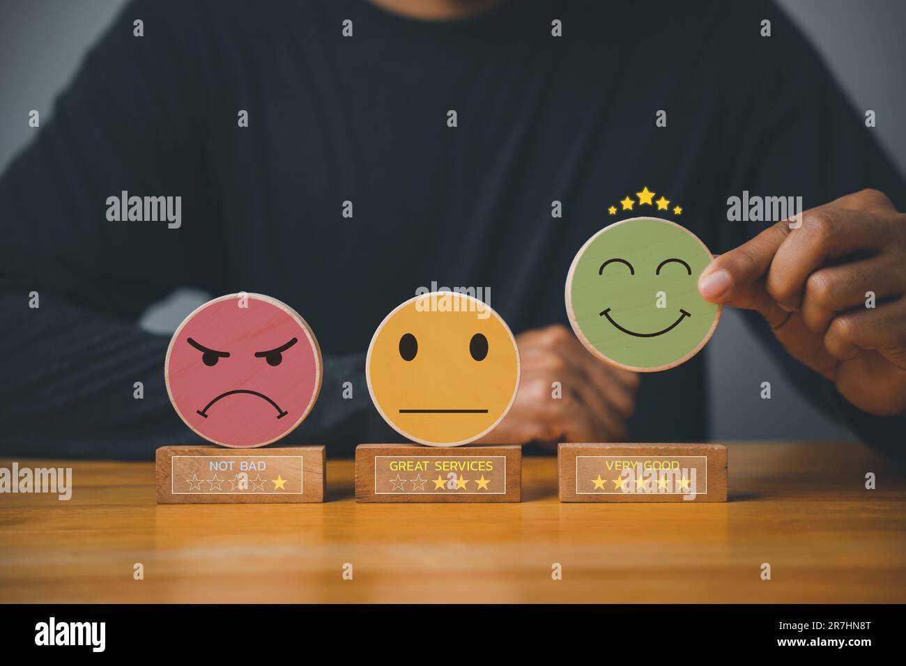 Selecting a smiley face on a wooden block circle Stock Photo - Alamy
