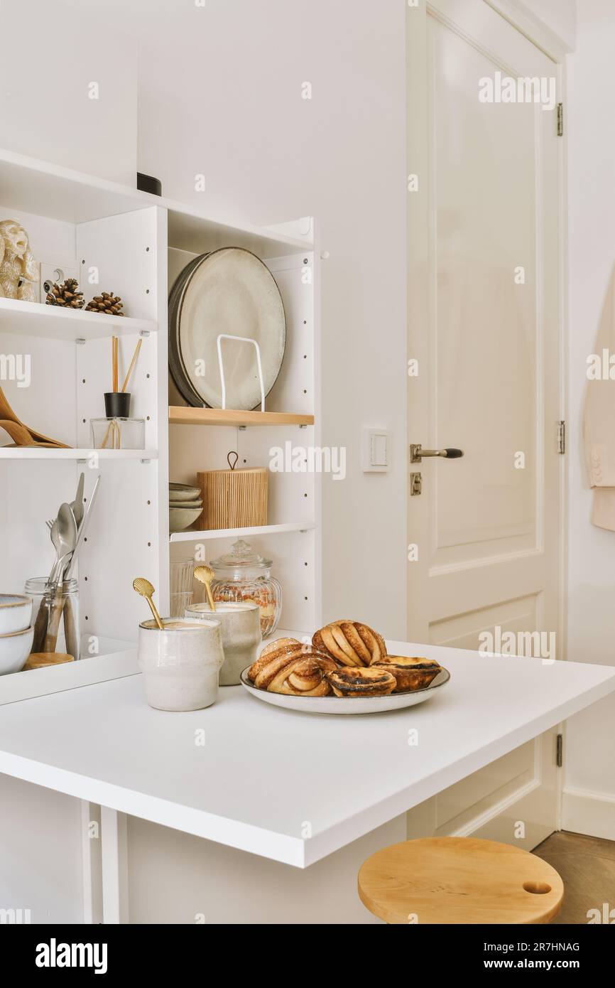 some food on a table in a room with white walls and open doors behind ...