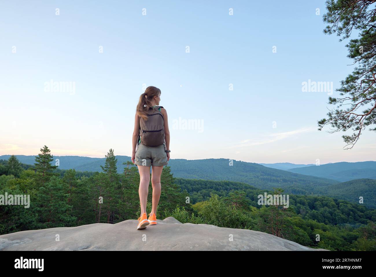 Hiker woman walking on mountain footpath enjoying evening nature ...