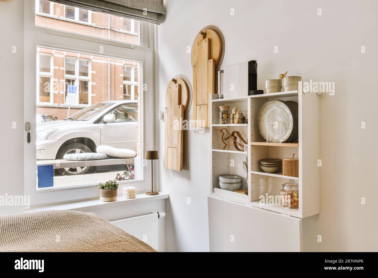 a room with a window and some items on the shelfs in front of the ...