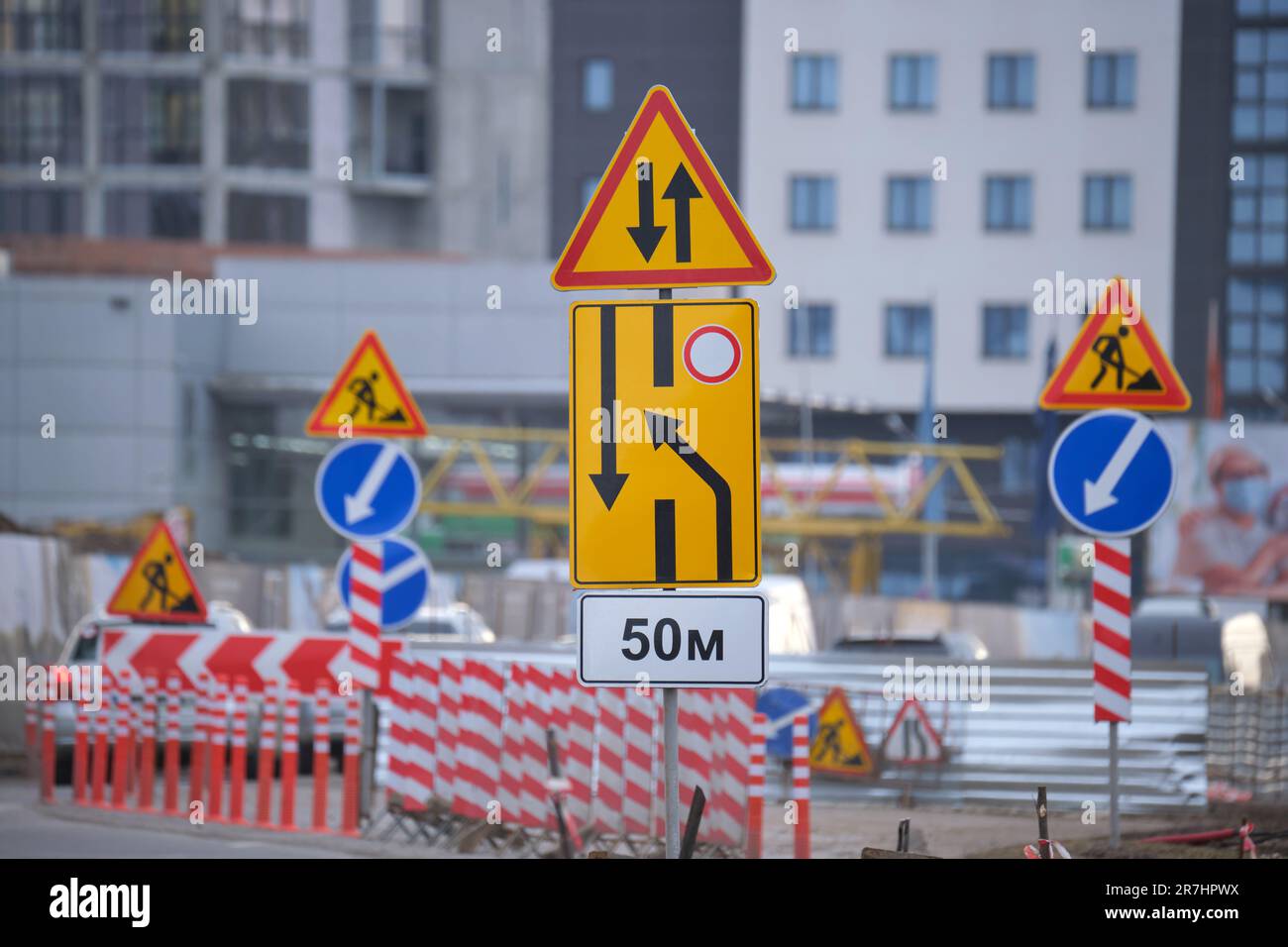 Roadworks warning traffic signs of construction work on city street and ...
