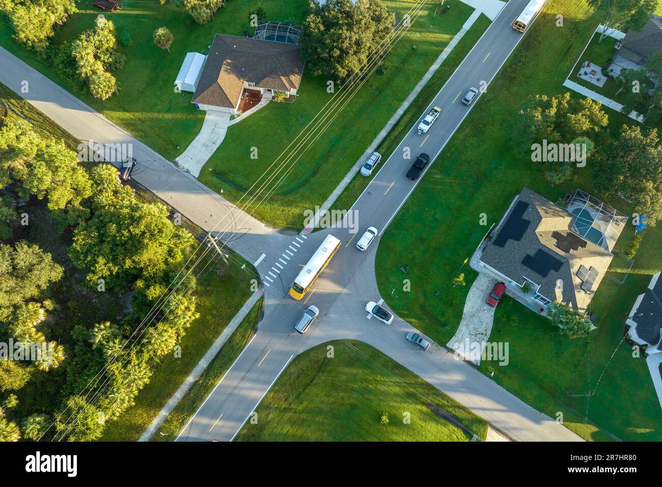 Top view of standard american yellow school bus picking up kids at ...