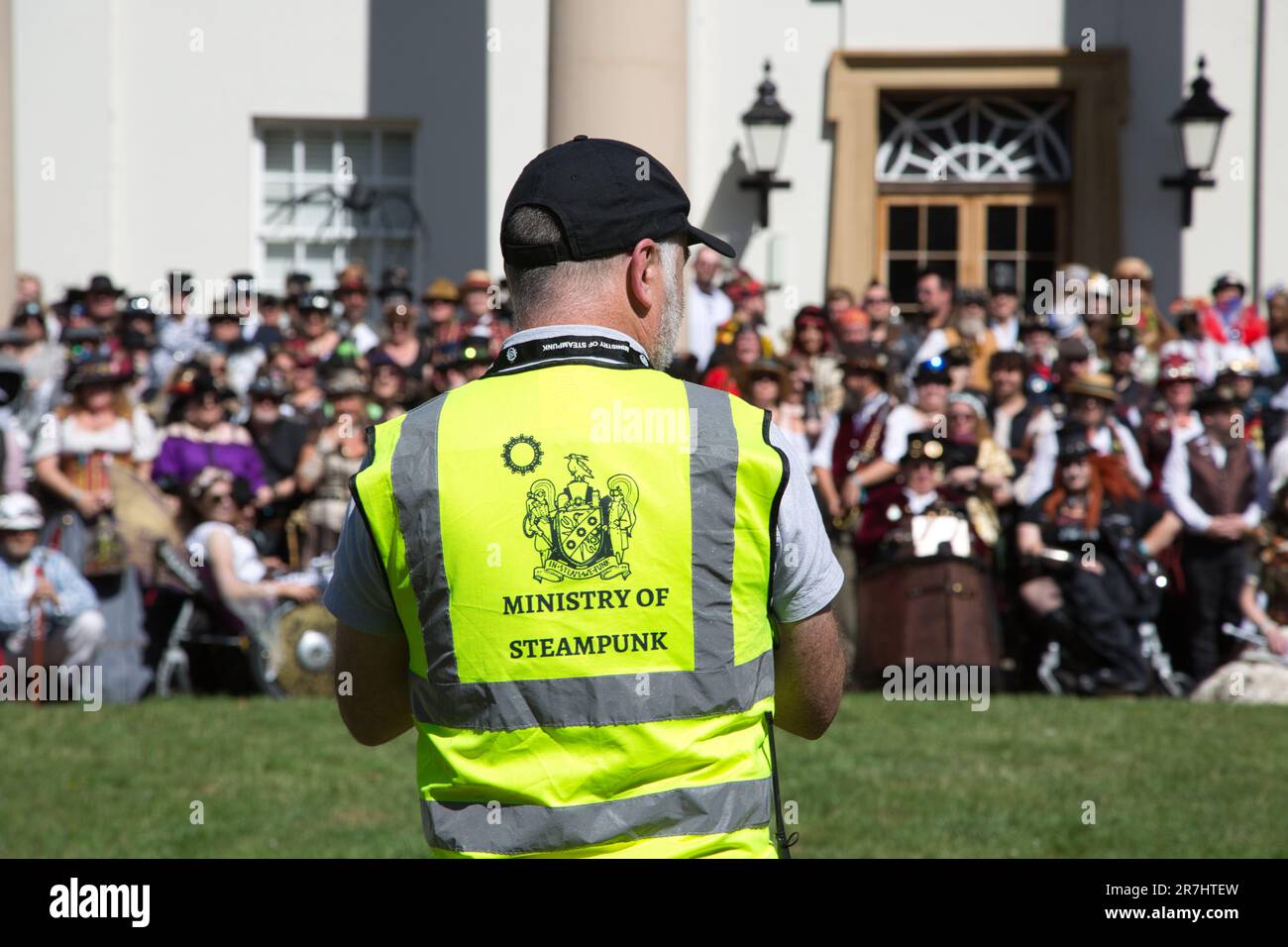 A security guard stands alertly on a busy city street, with a diverse ...