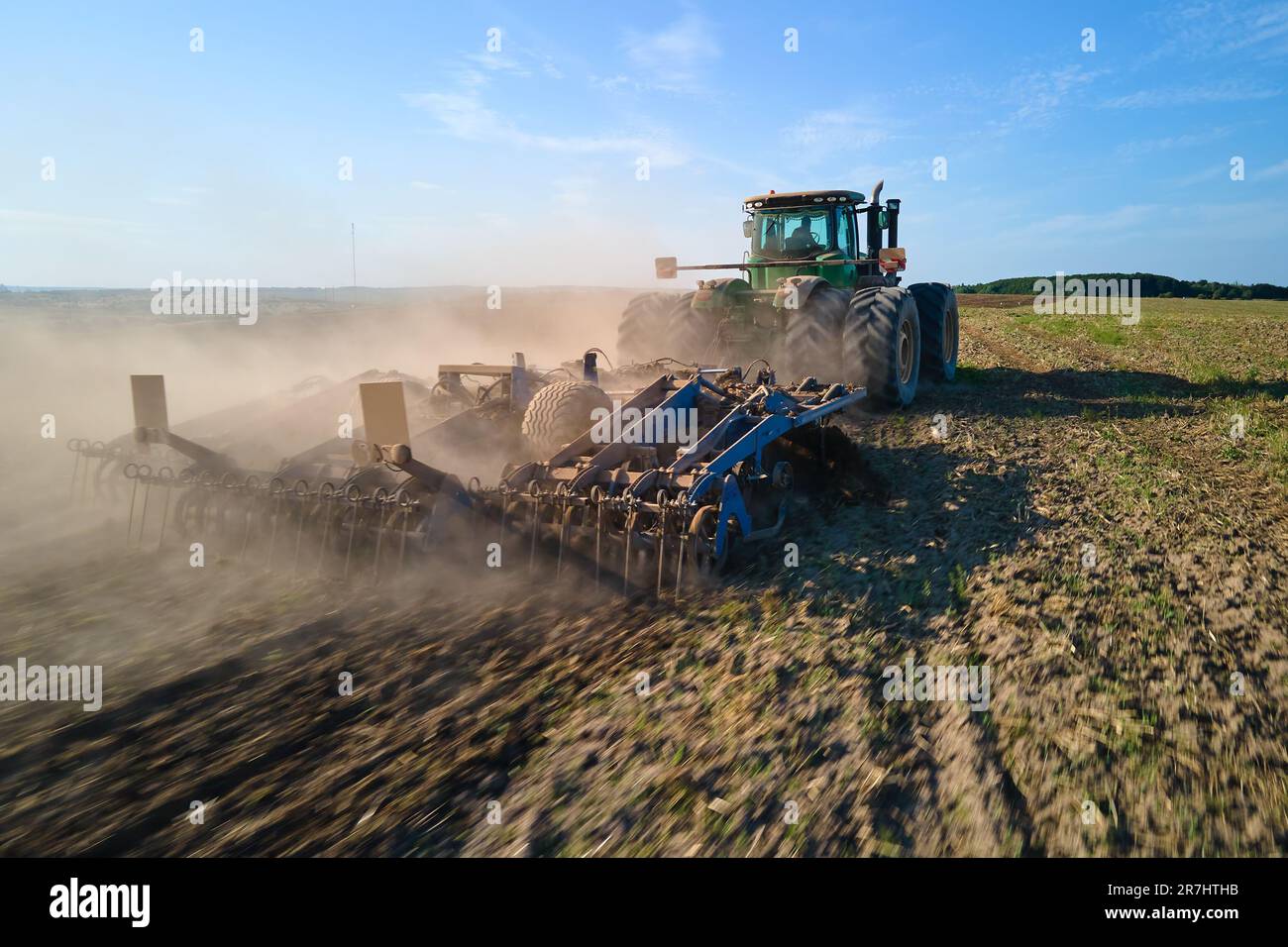 Aerial view of tractor plowing agriculural farm field preparing soil ...