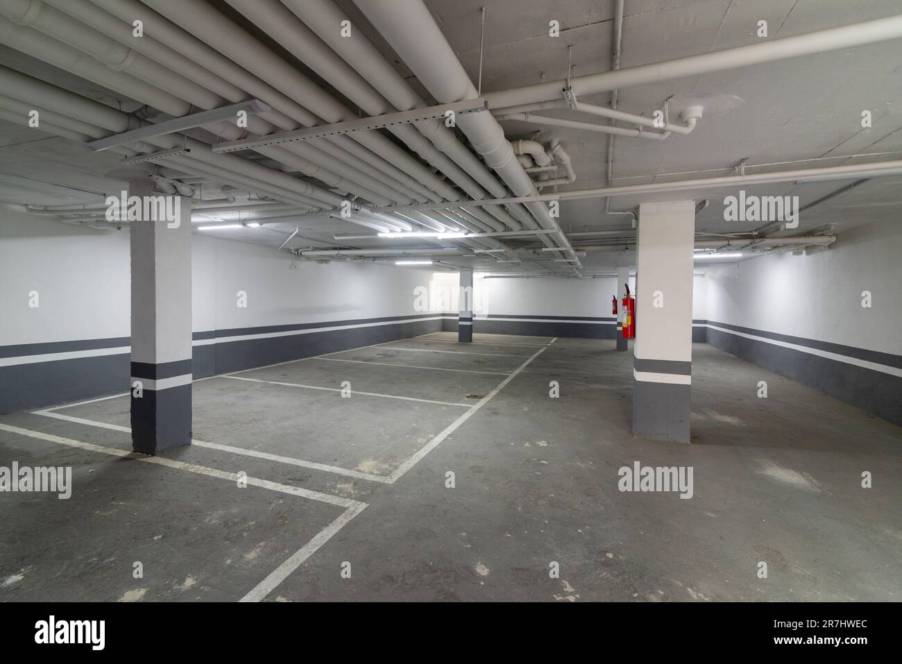 An empty industrial parking garage with concrete floors and ceilings ...