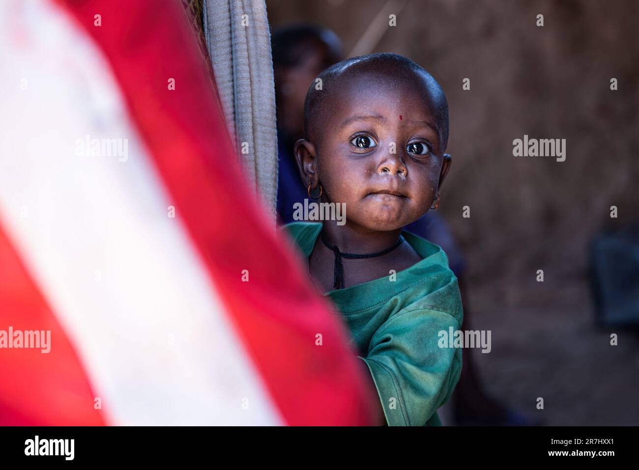 Little Birkit from T'afa village, poses as her parents are being interviewed. Tigray, the ...