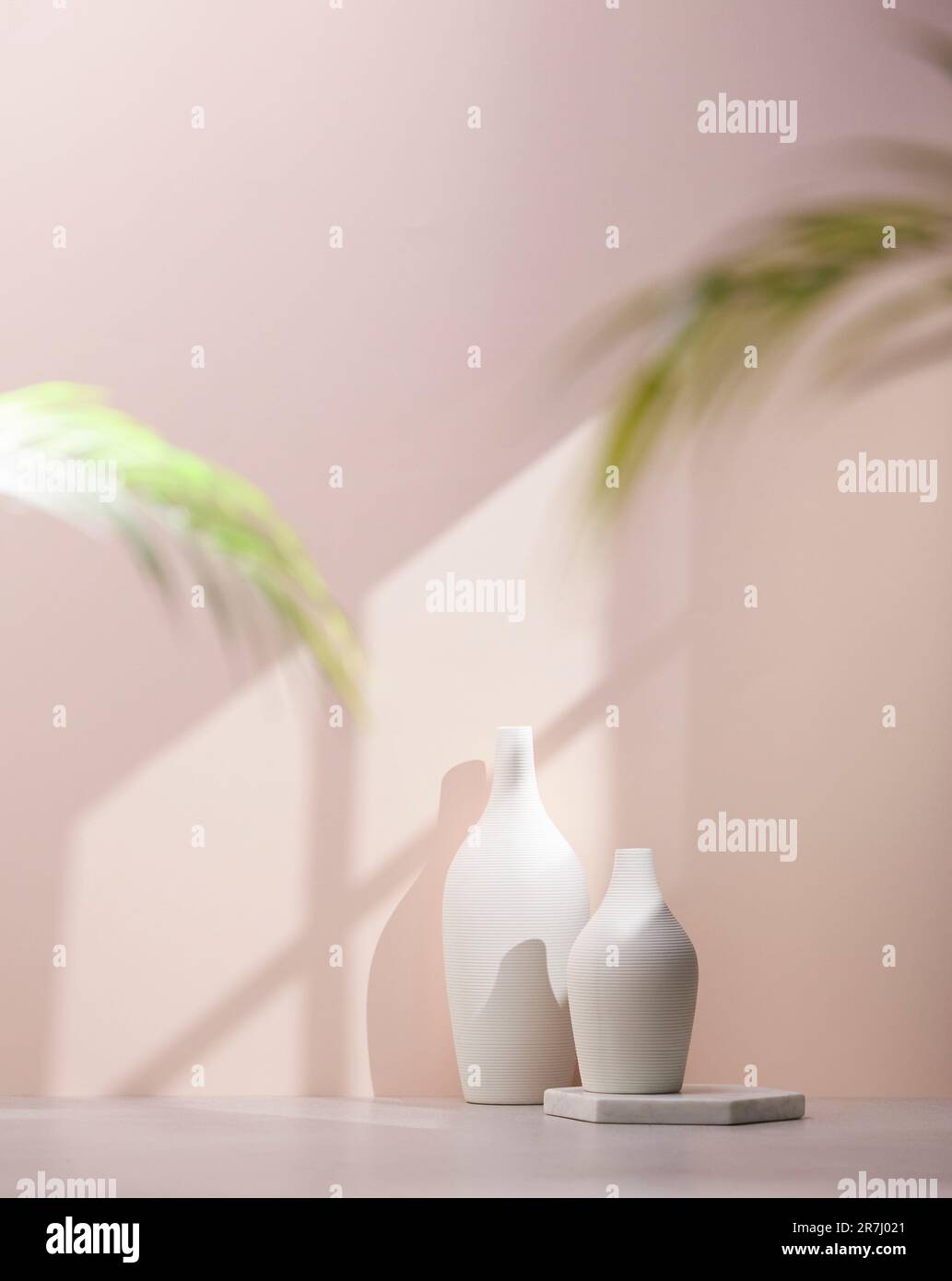 Vases and objects on the table in a warm room with sunlight coming in ...