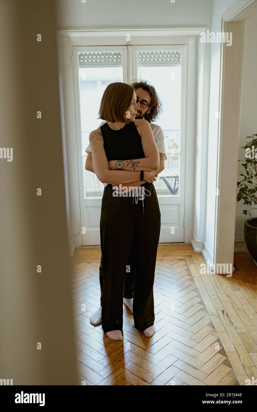 Romantic couple hugging and enjoying time together while standing at ...