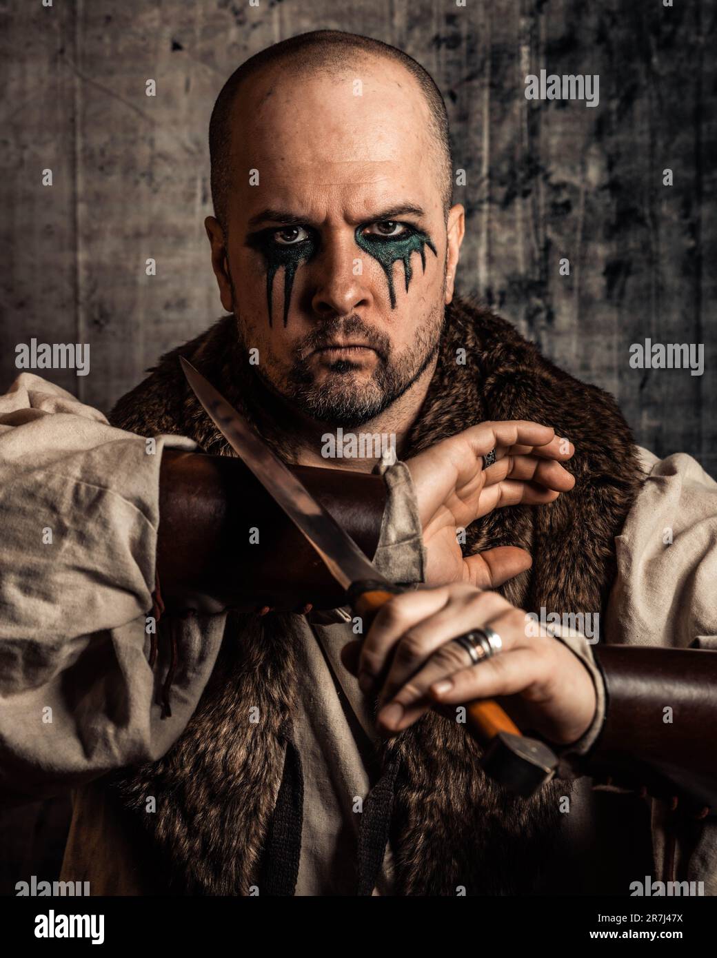 A man dressed in authentic medieval armor standing in the middle of ...
