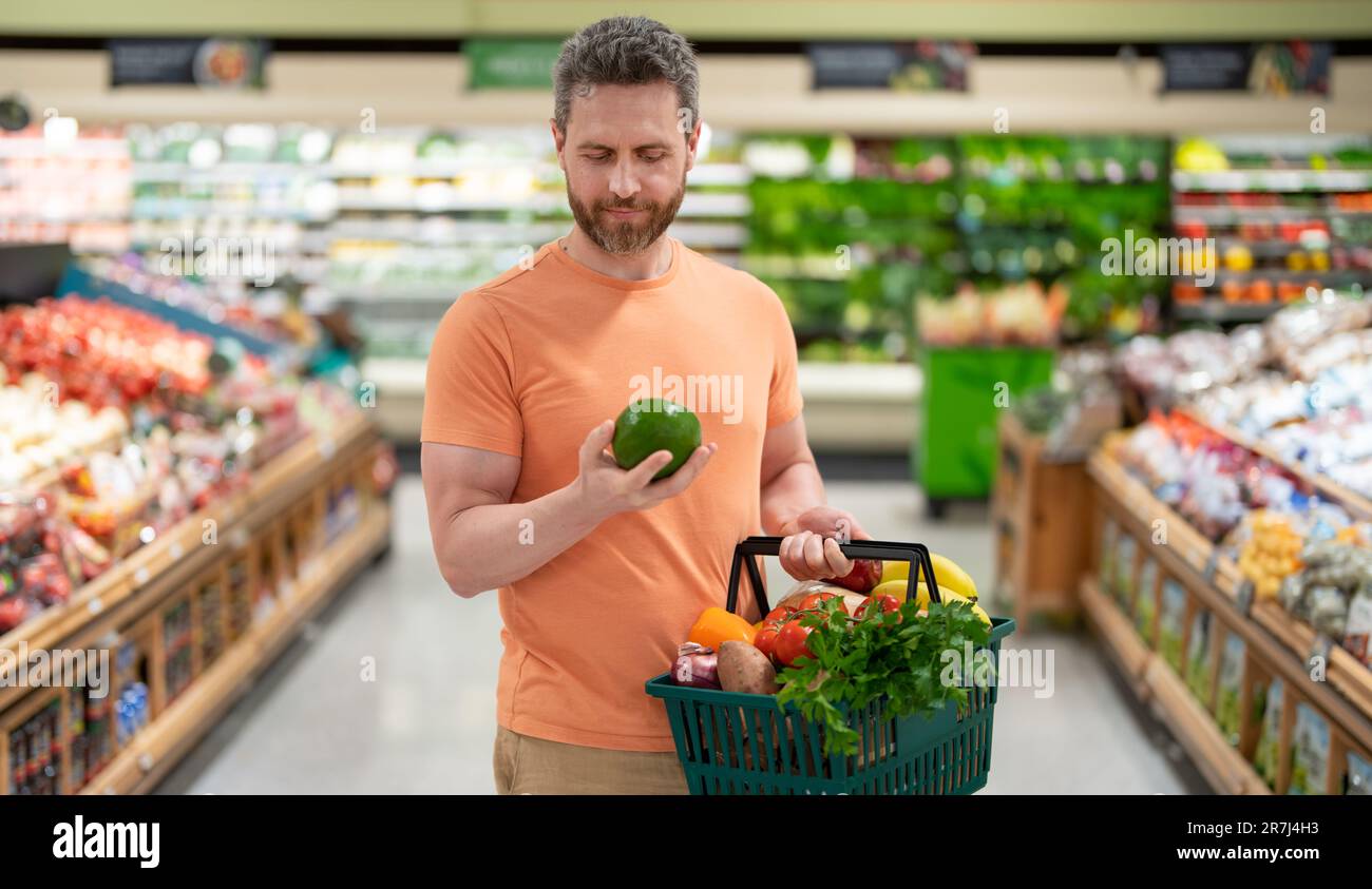 Man with fruits and vegetables at grocery store. Healthy food for mens ...