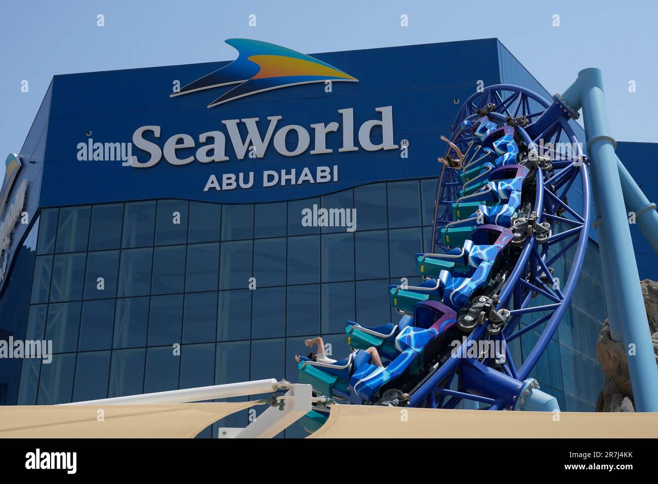 People enjoy riding on a roller coaster at the SeaWorld on Yas Island ...