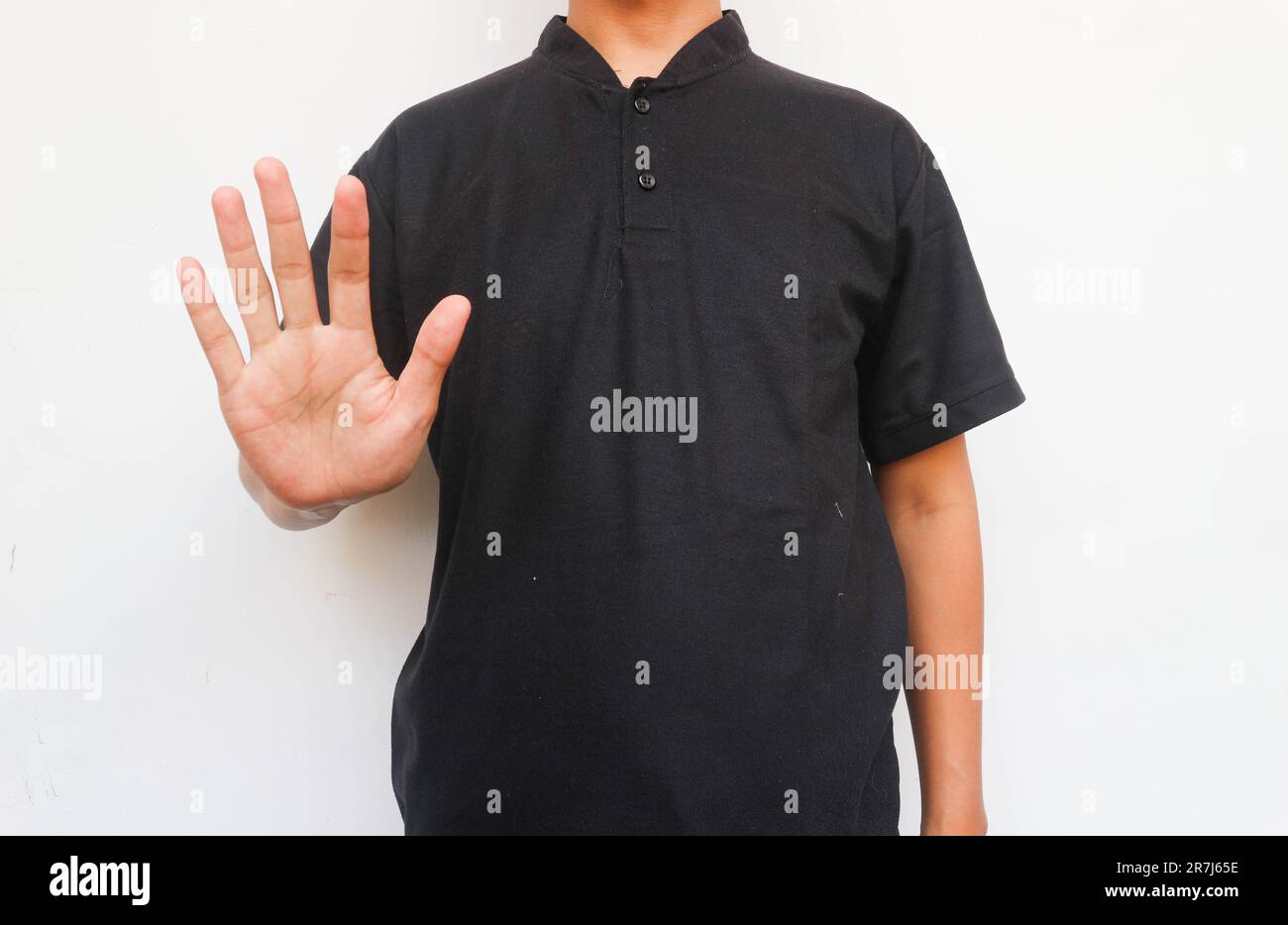 The man with the black shirt raised his hand to show stop sign Stock ...