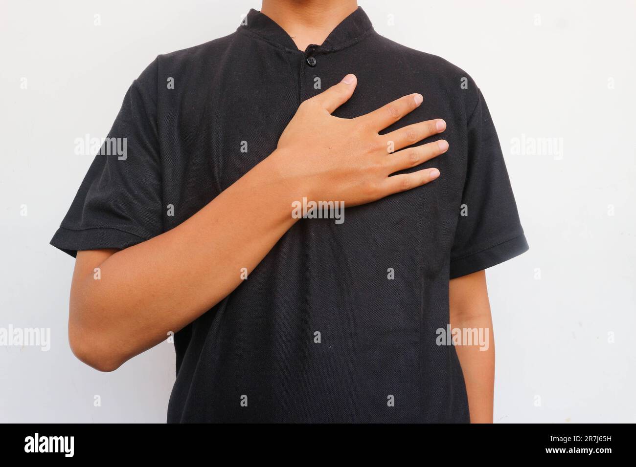 The man in the black shirt placed one hand on his chest in greeting ...