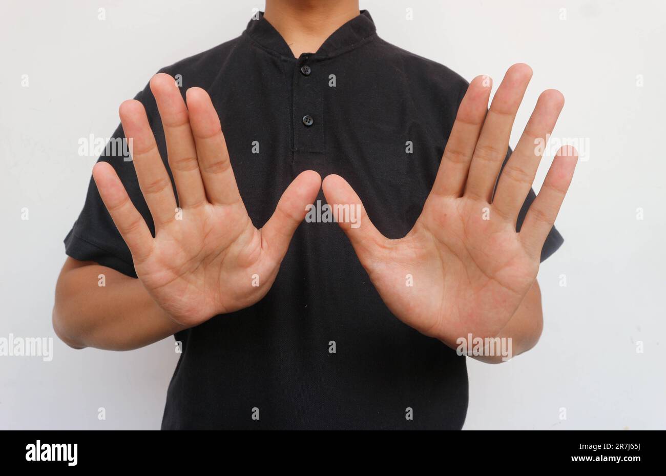 The man with the black shirt raised his hands to show stop sign Stock ...