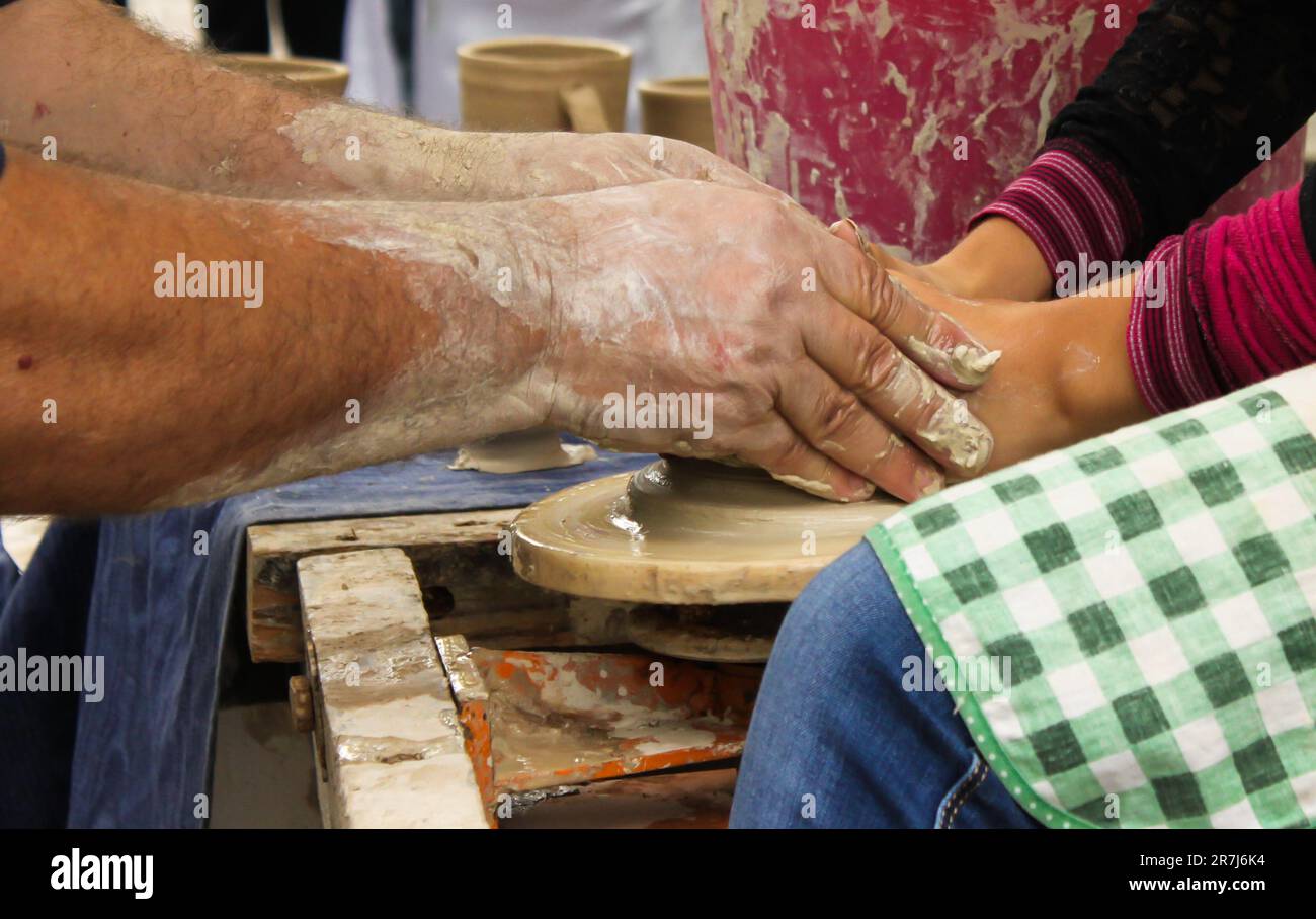 hands of teacher and student while learning pottery Stock Photo - Alamy